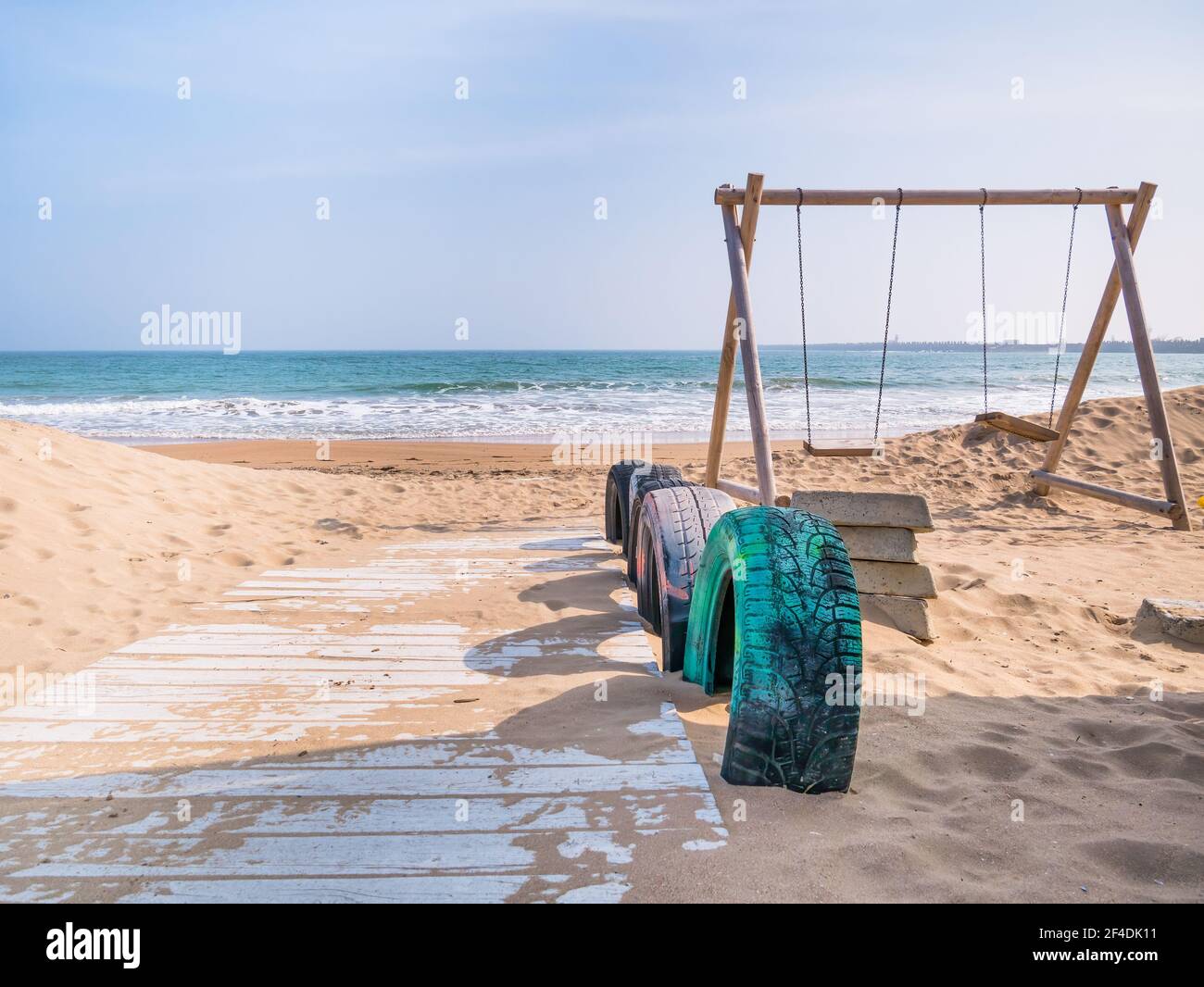 Wooden board path over the sand and swings at Mangalia beach, in ...