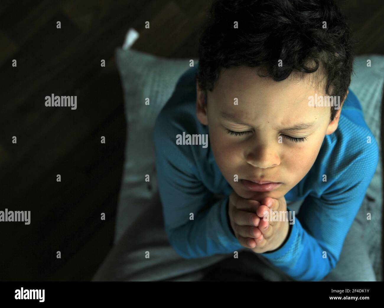 boy praying to God with hands together on white background stock photo ...