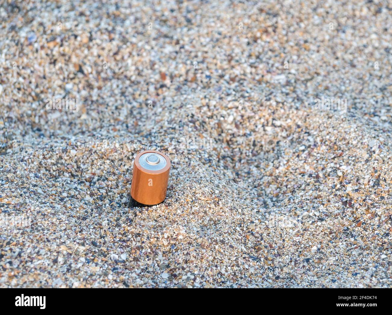 Improperly disposed batteries in the sand on the beach.Used waste ...