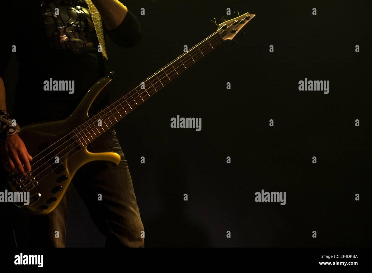 the bass guitarist is resting during the concert break Stock Photo - Alamy