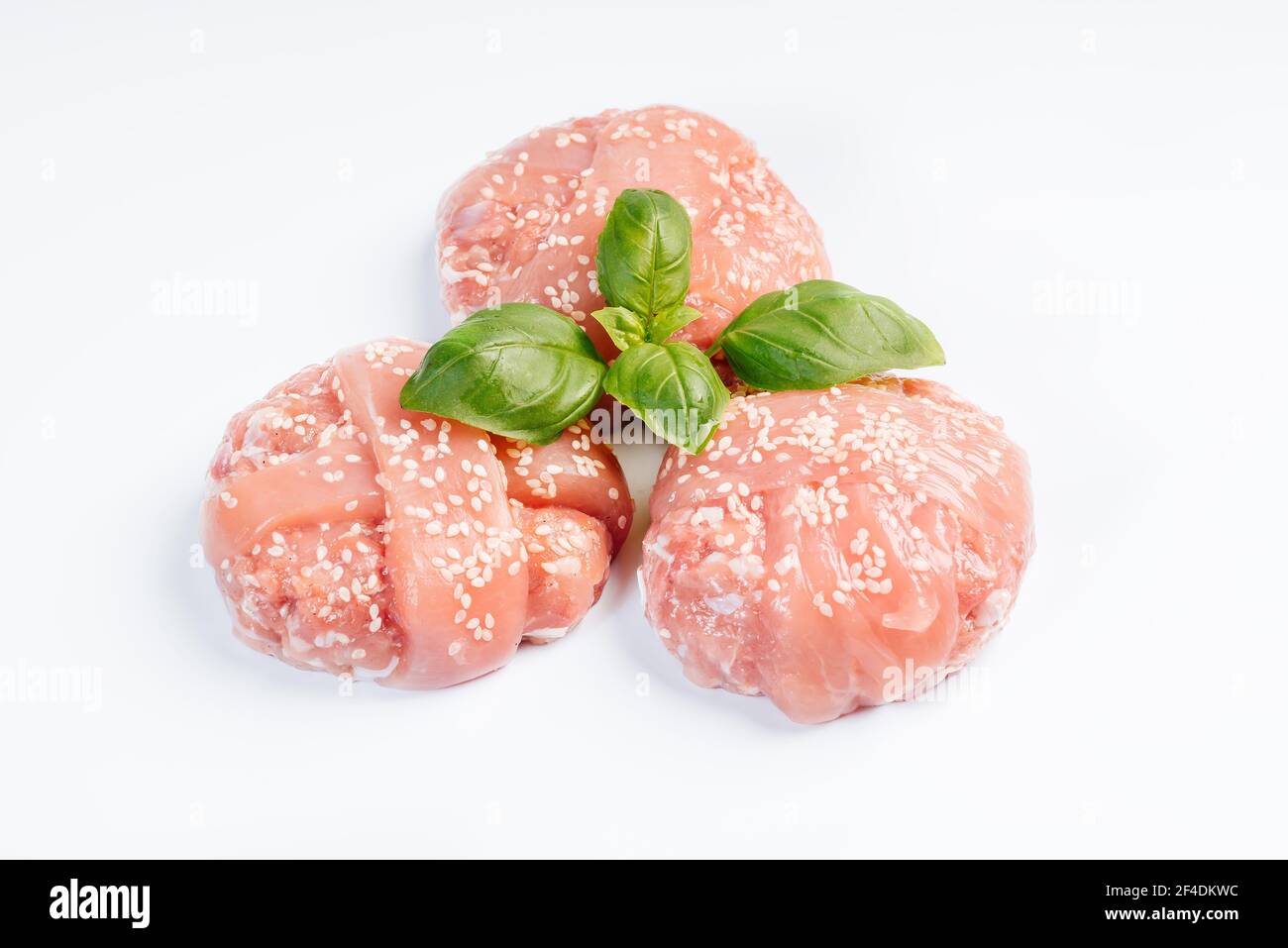 Grilled hamburgers.Raw chicken burger with basil leaves and spices on a ...
