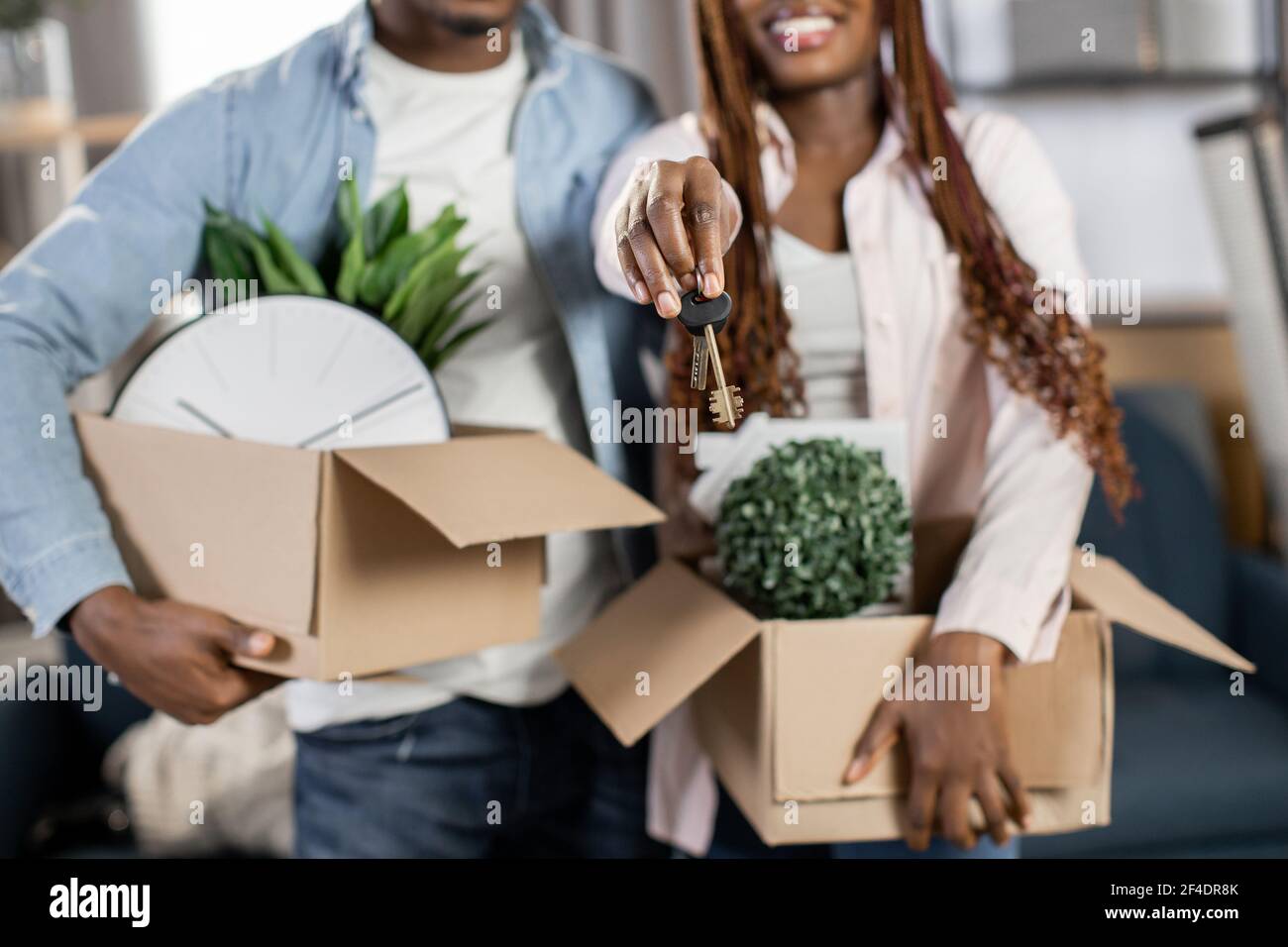 Close up of african couple showing keys from their new modern house ...