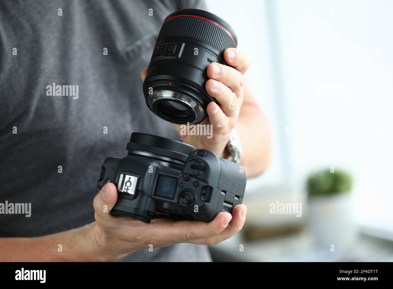 Male hands putting on modern digital camera professional lens Stock ...