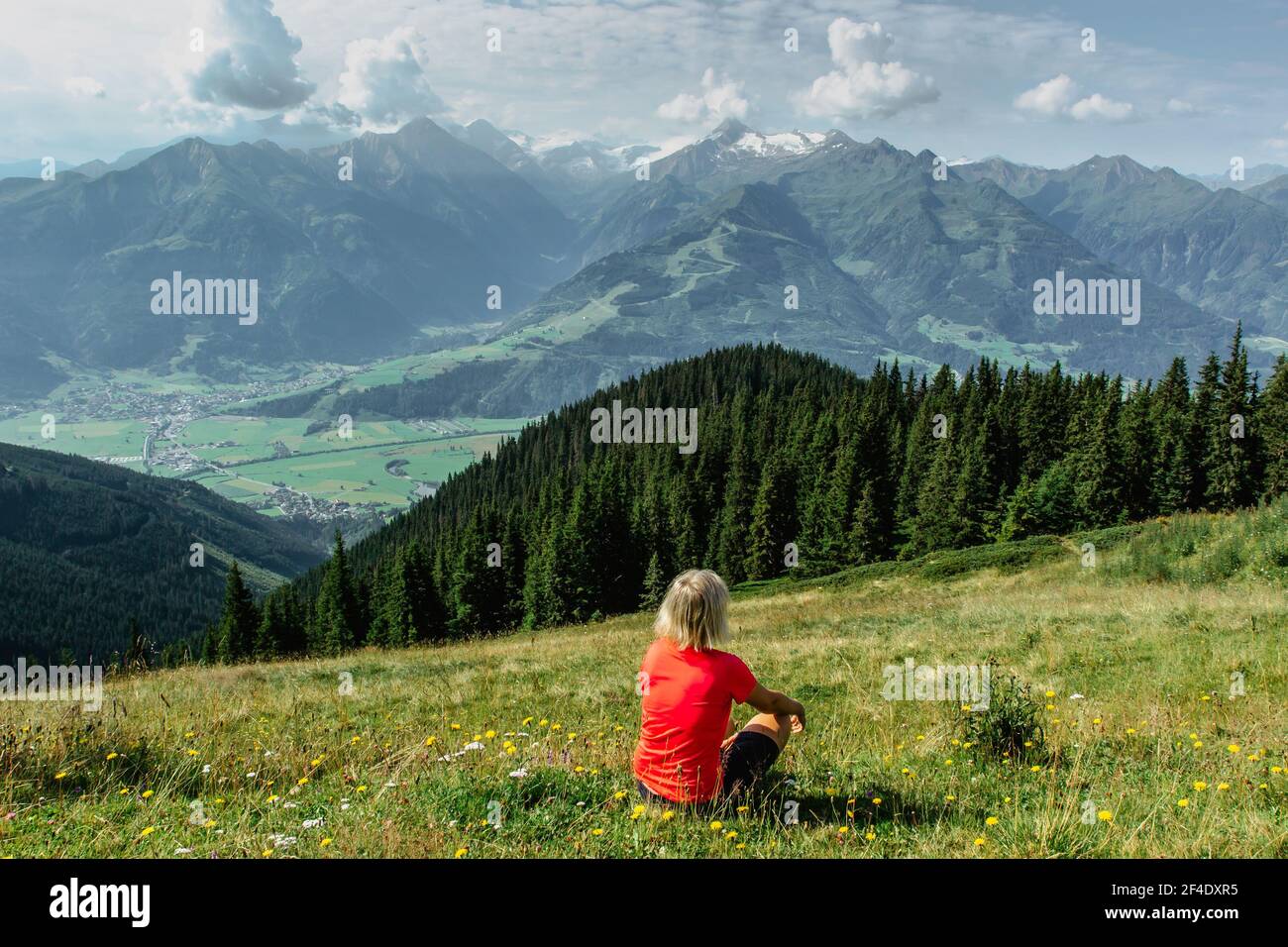 Blonde girl enjoying view during trekking in Alps, Austria.Majestic ...