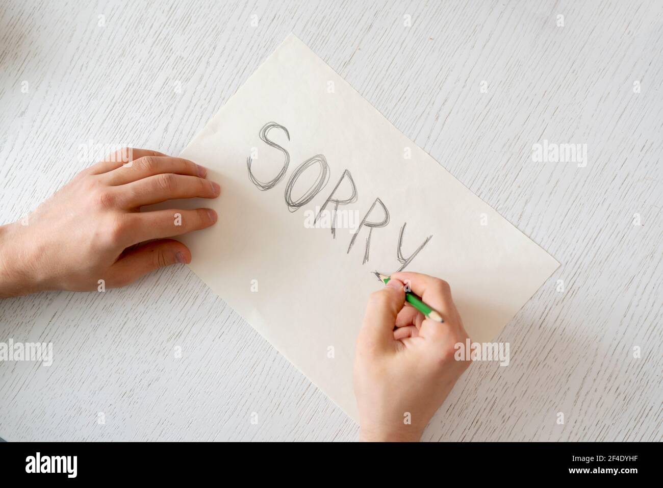 a person hands holding a paper sheet with the sorry word Stock Photo ...