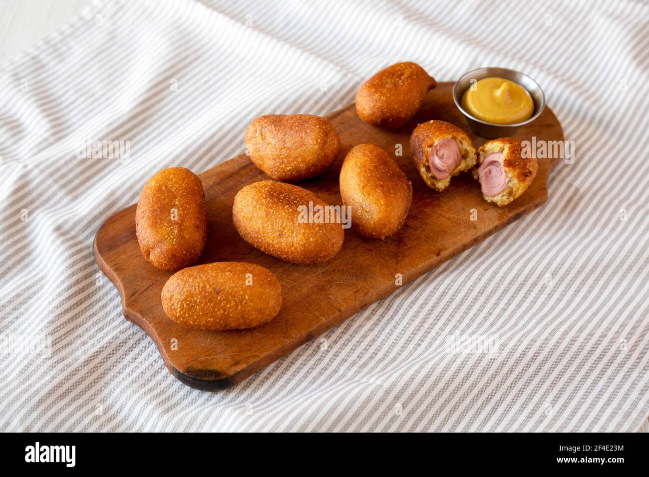 Homemade Mini Corn Dogs on a rustic wooden board, side view Stock Photo ...
