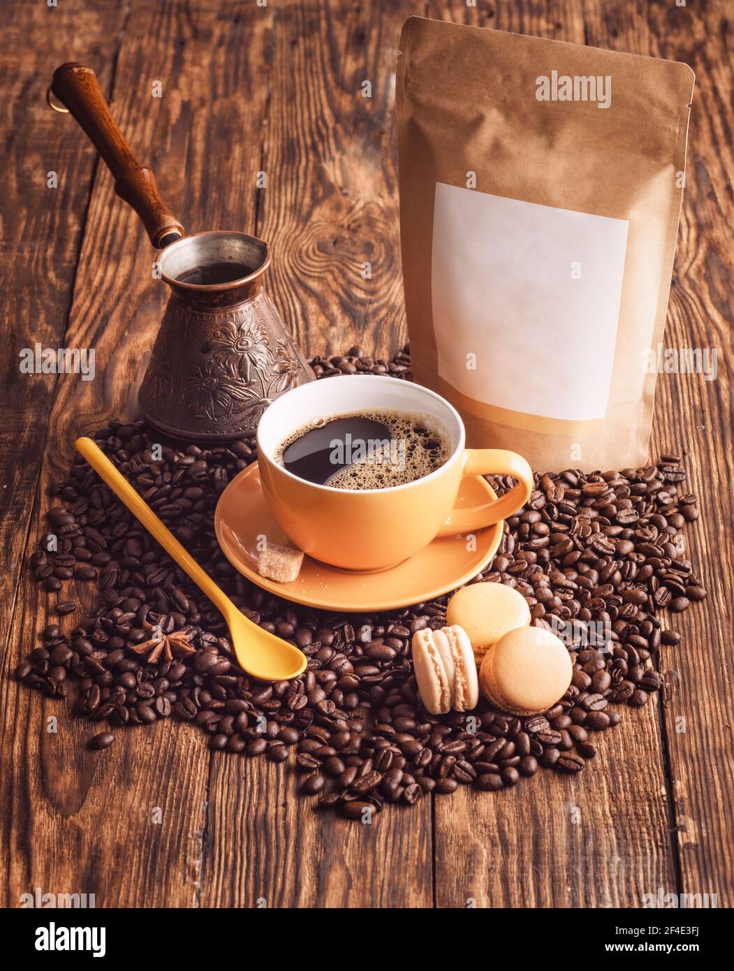 yellow cup of coffee, macaroons, beans, turkish coffee pot, and craft ...
