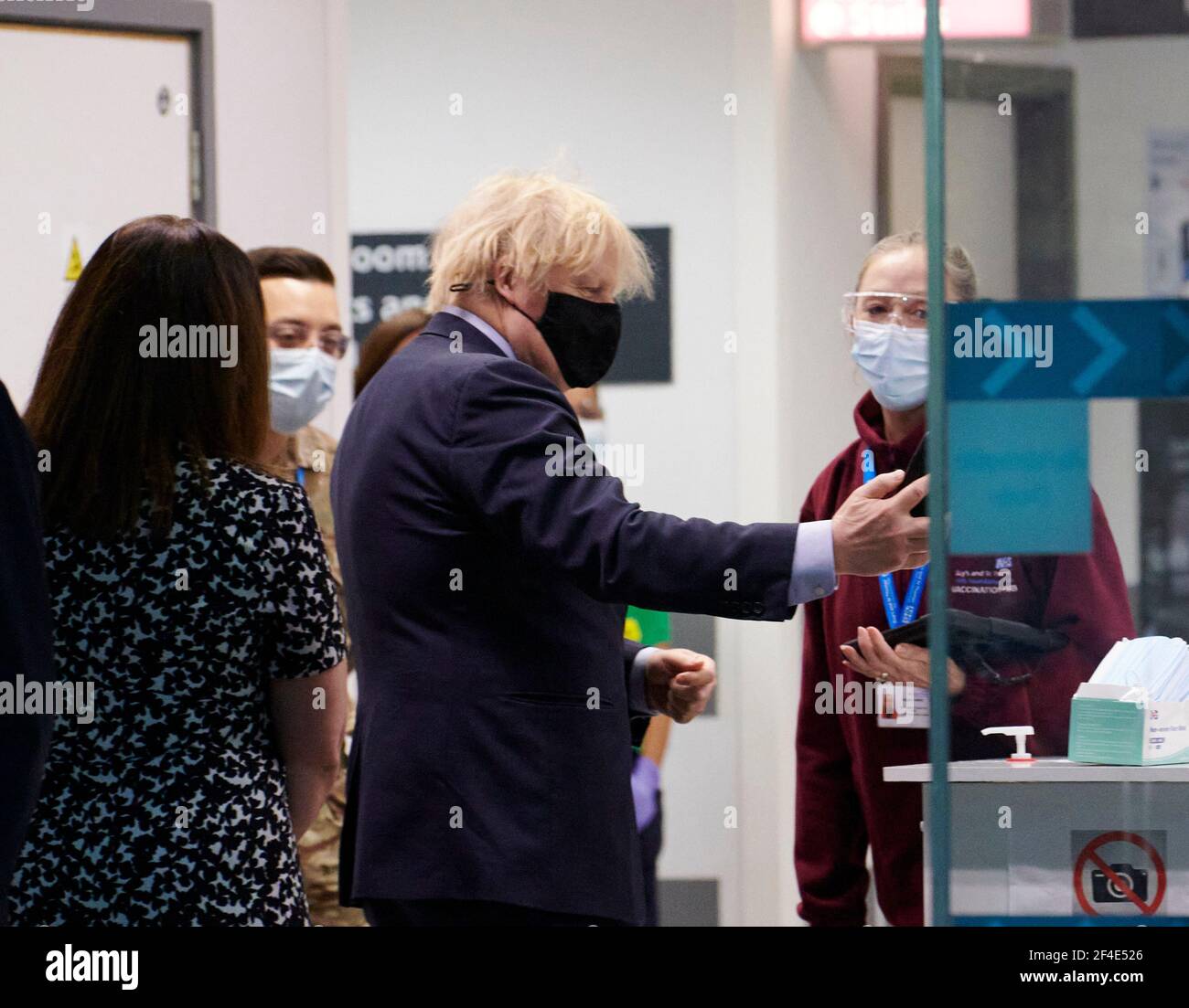 London, UK. 19th March 2021. Boris Johnson takes a selfie with staff at ...
