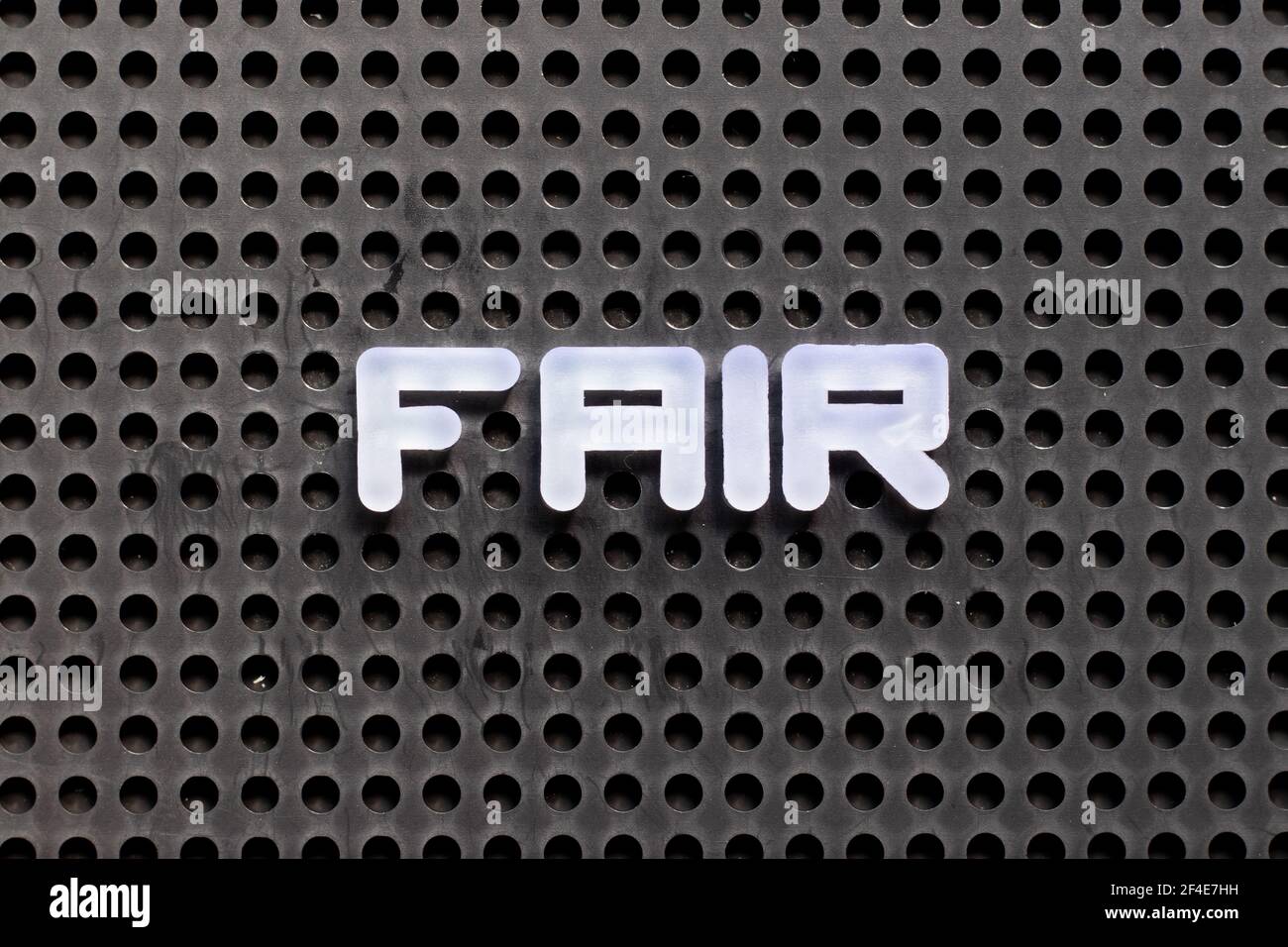 White color letter in word fair on black pegboard background Stock ...