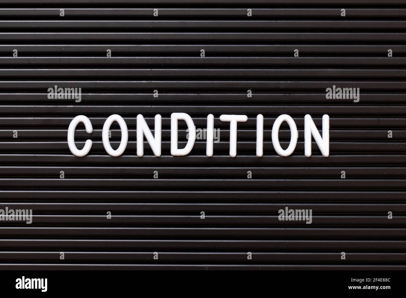 White alphabet in word condition on black color felt letter board ...