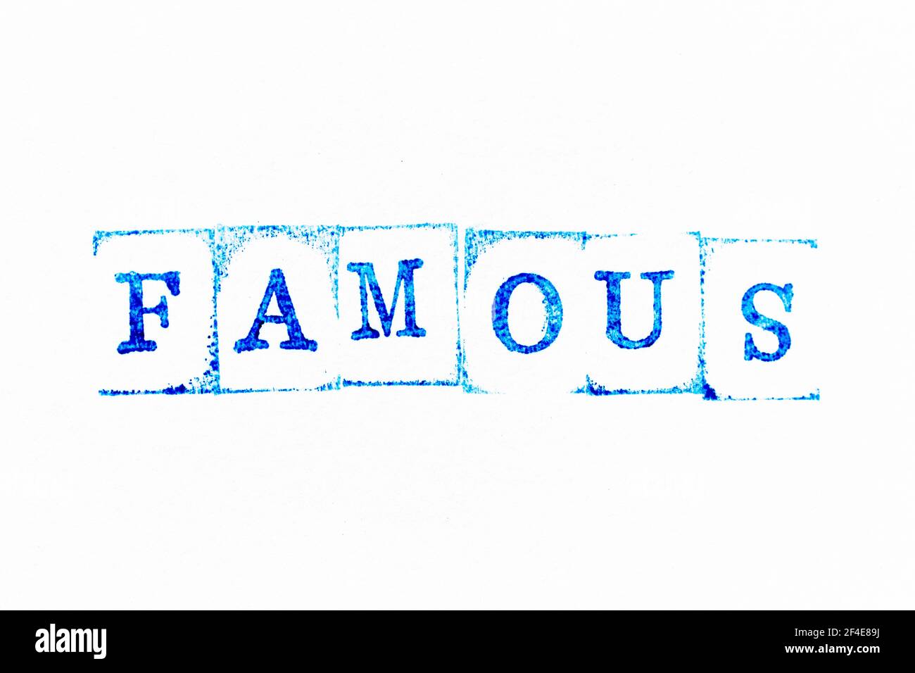 Blue color ink rubber stamp in word famous on white paper background ...