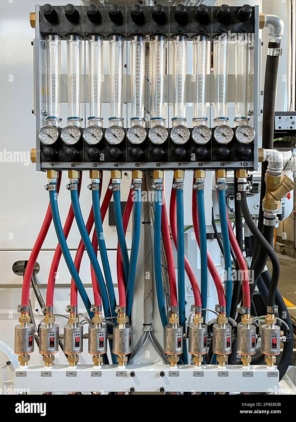 circuit with blue and red hoses connecting graduated test tubes with ...