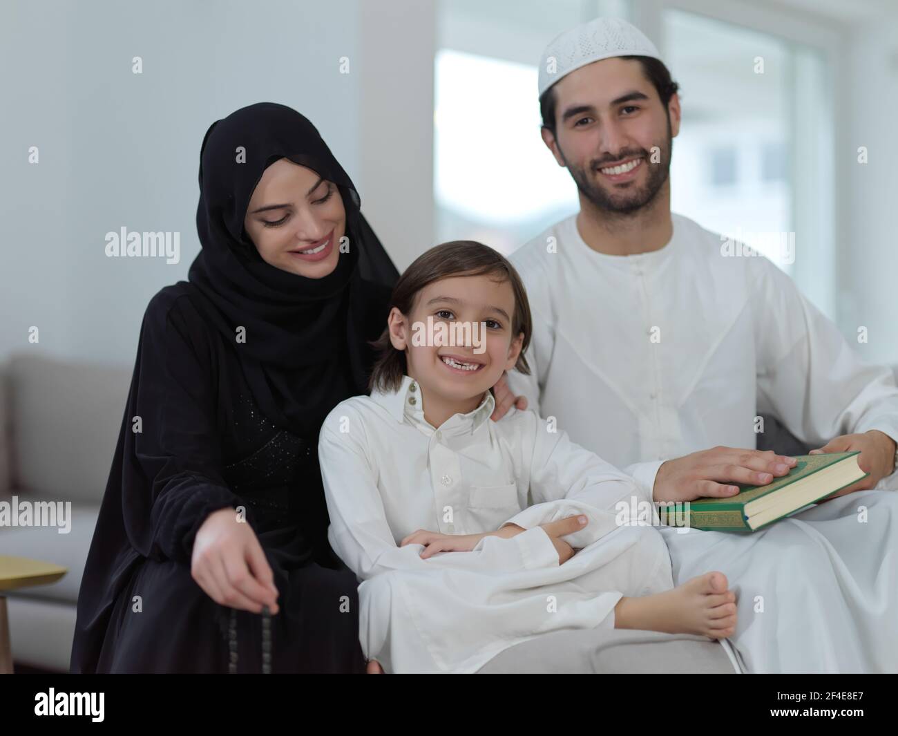 Young muslim family reading Quran during Ramadan Stock Photo - Alamy