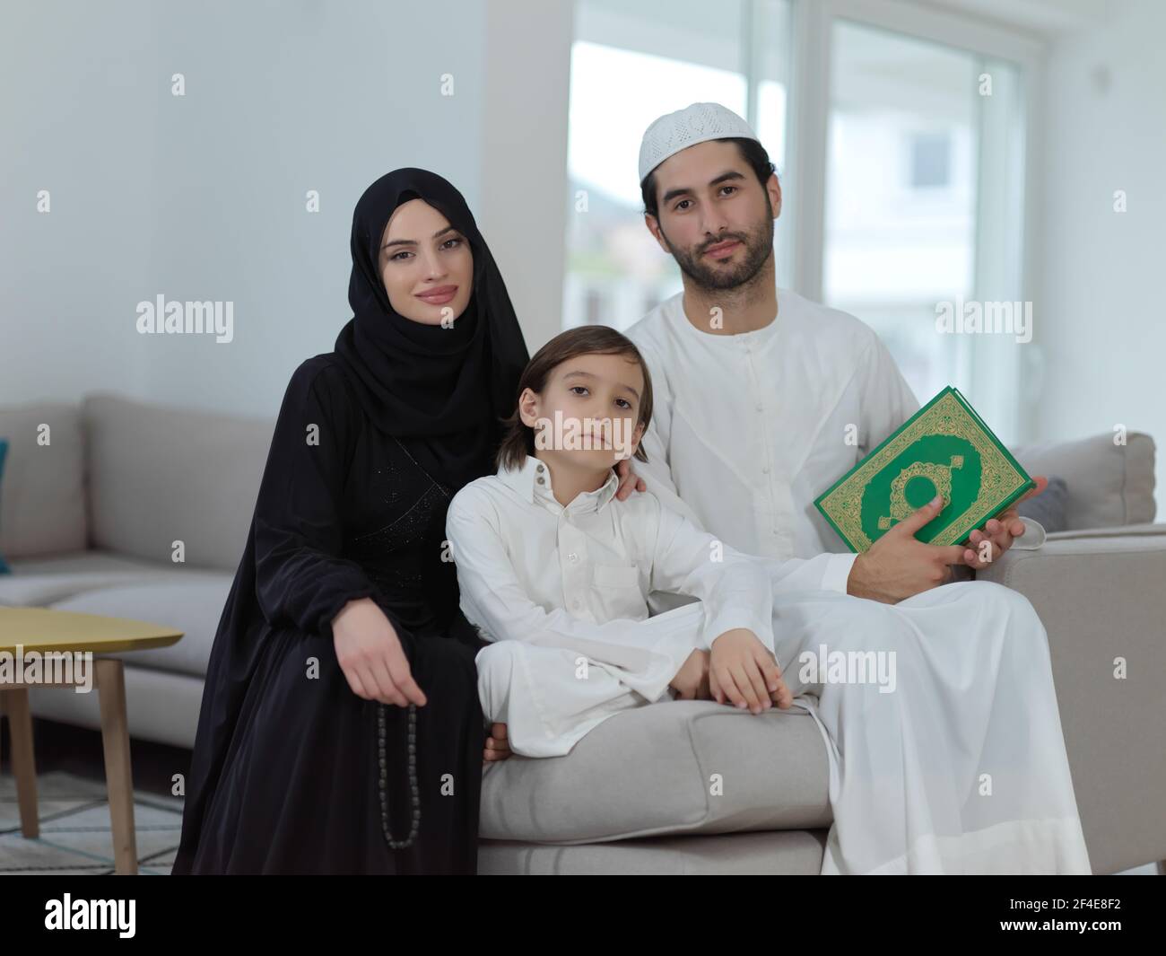 Young muslim family reading Quran during Ramadan Stock Photo - Alamy