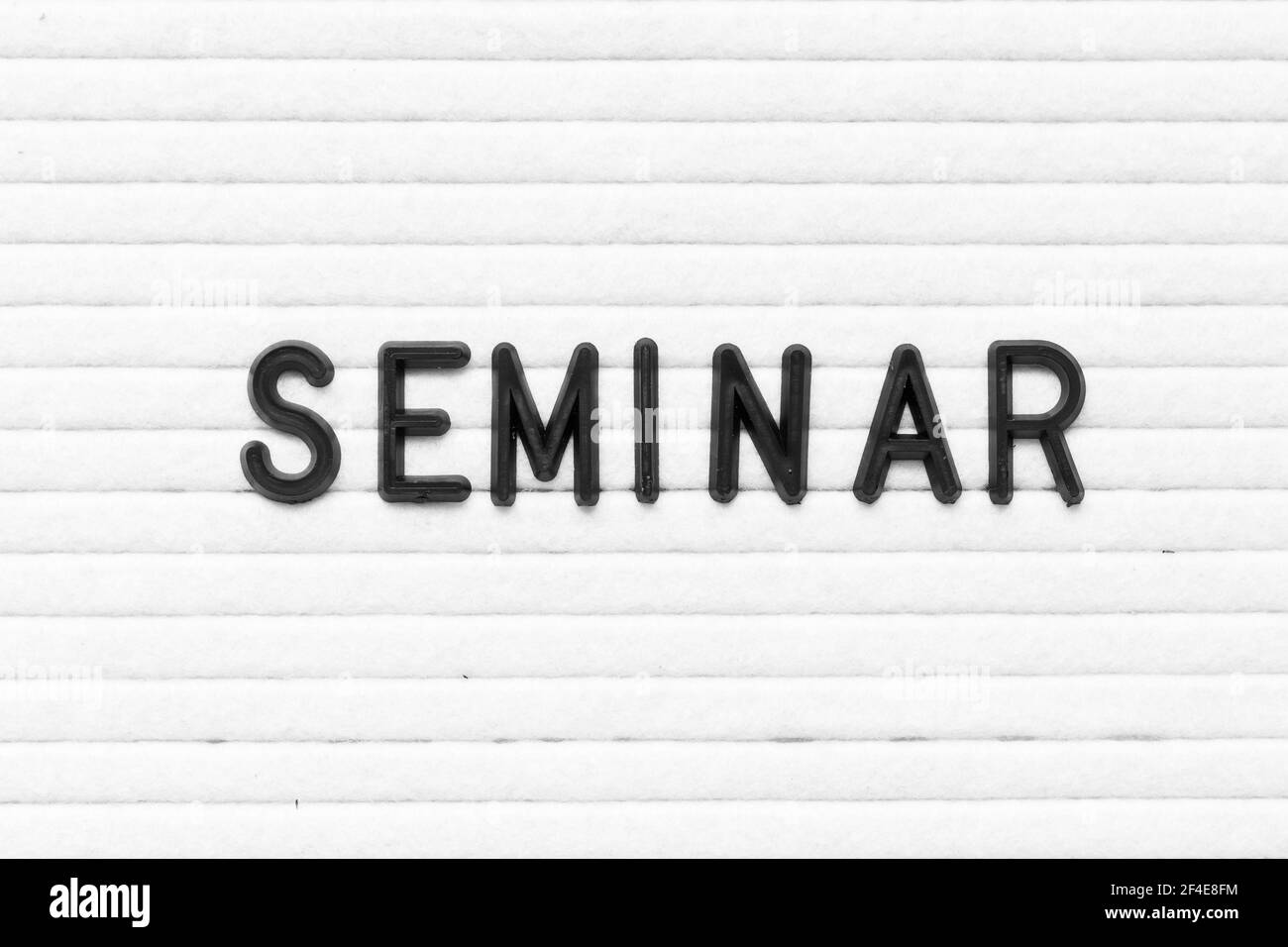 Black color letter in word seminar on white felt board background Stock ...
