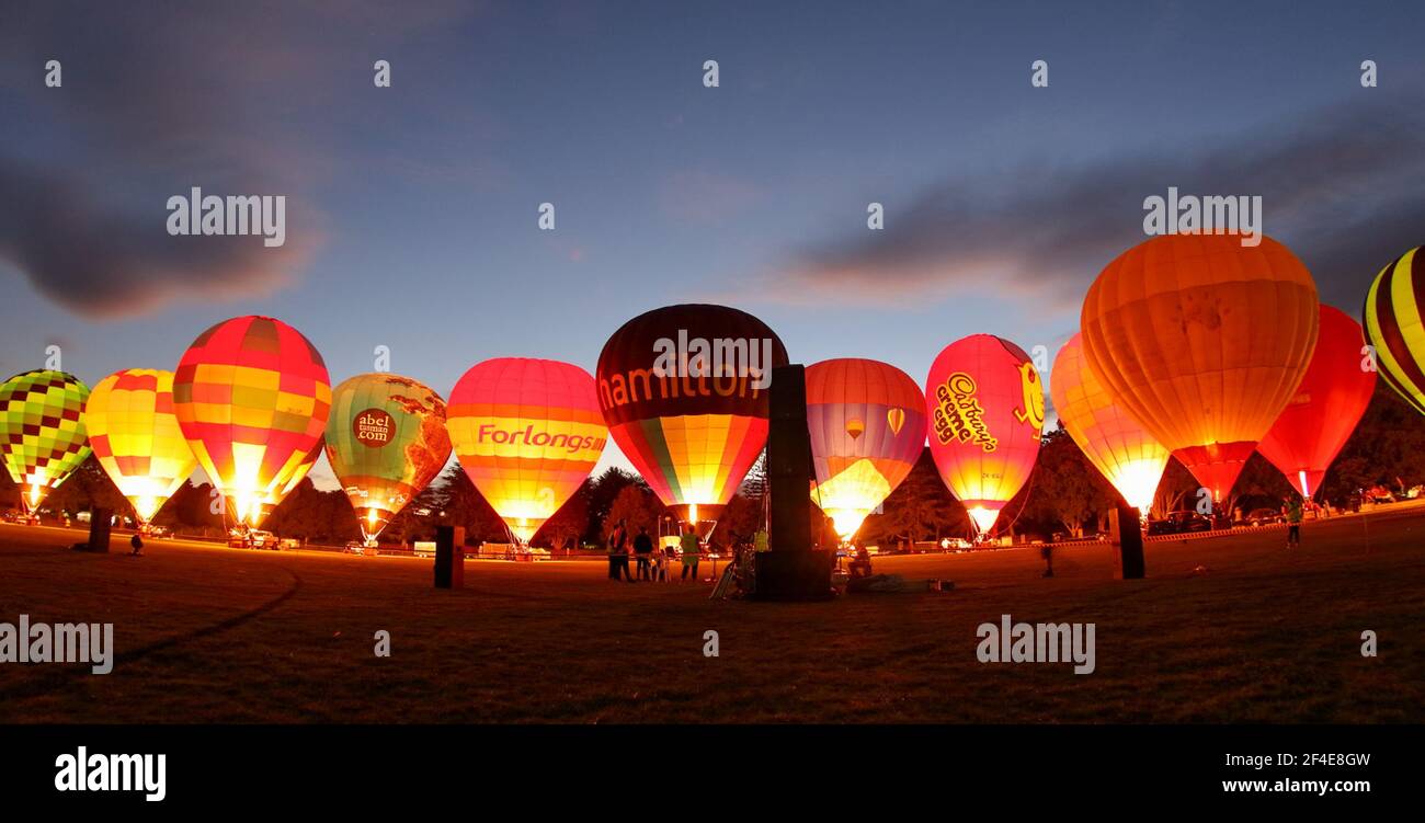 Hamilton, New Zealand. 20th Mar, 2021. People light hot air ballons ...