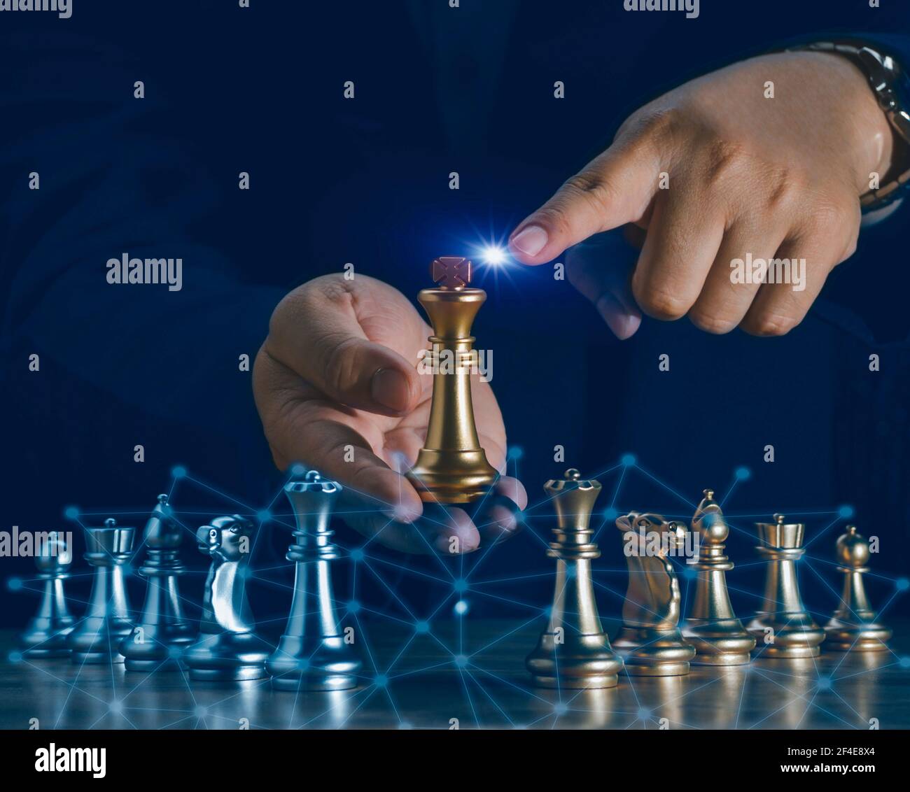 Hand businessman moving the golden knight chess fighting silver knight ...