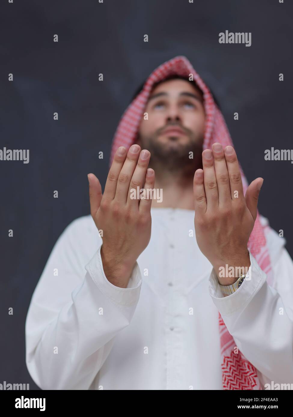 Arab man in traditional clothes praying to God or making dua Stock ...
