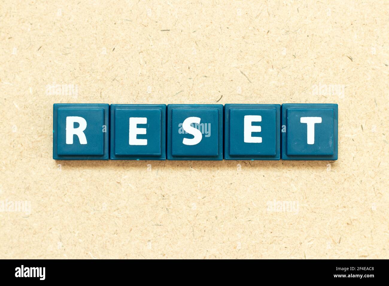 Tile alphabet letter in word reset on wood background Stock Photo - Alamy