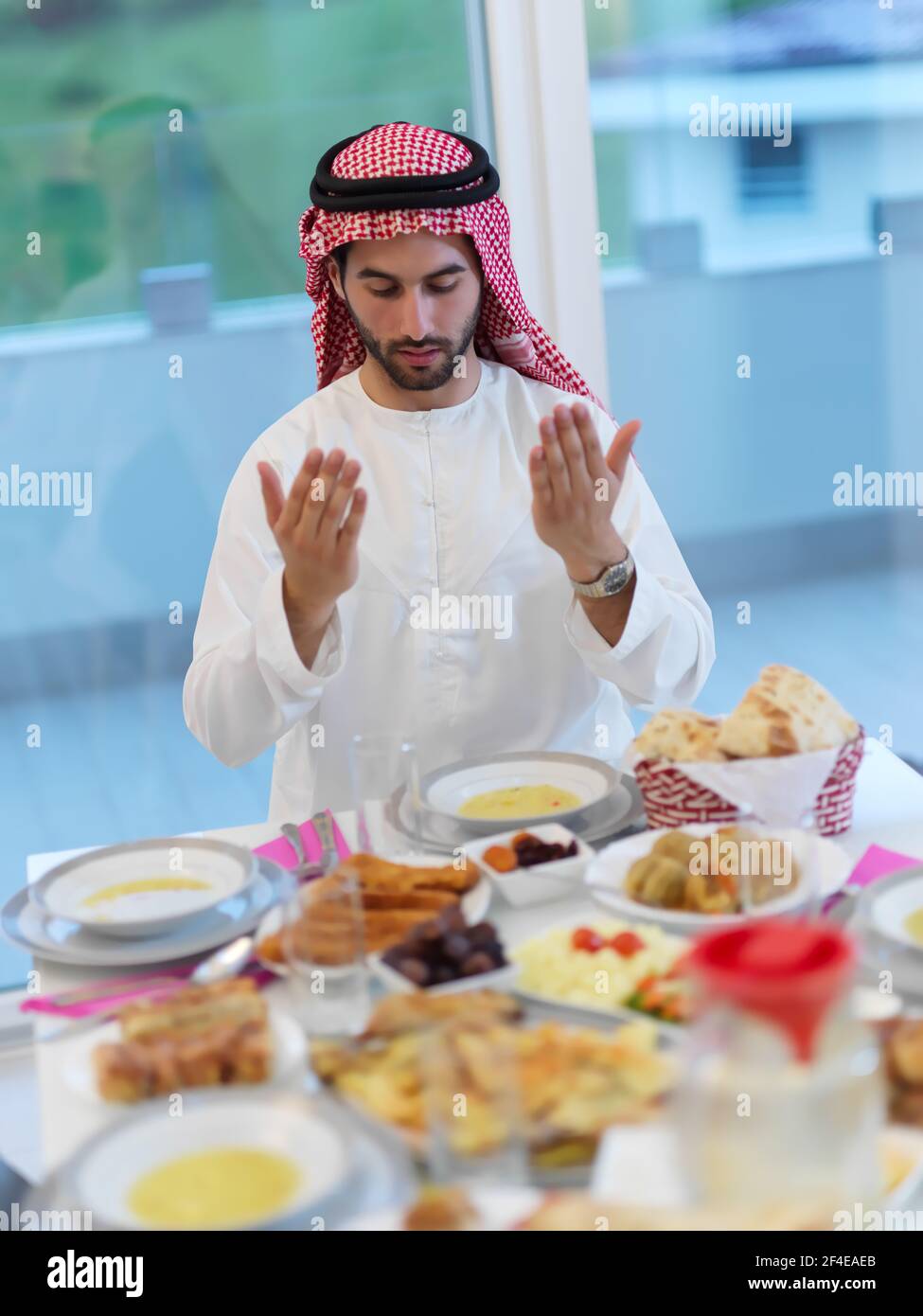 Muslim man making iftar dua to break fasting during Ramadan Stock Photo ...