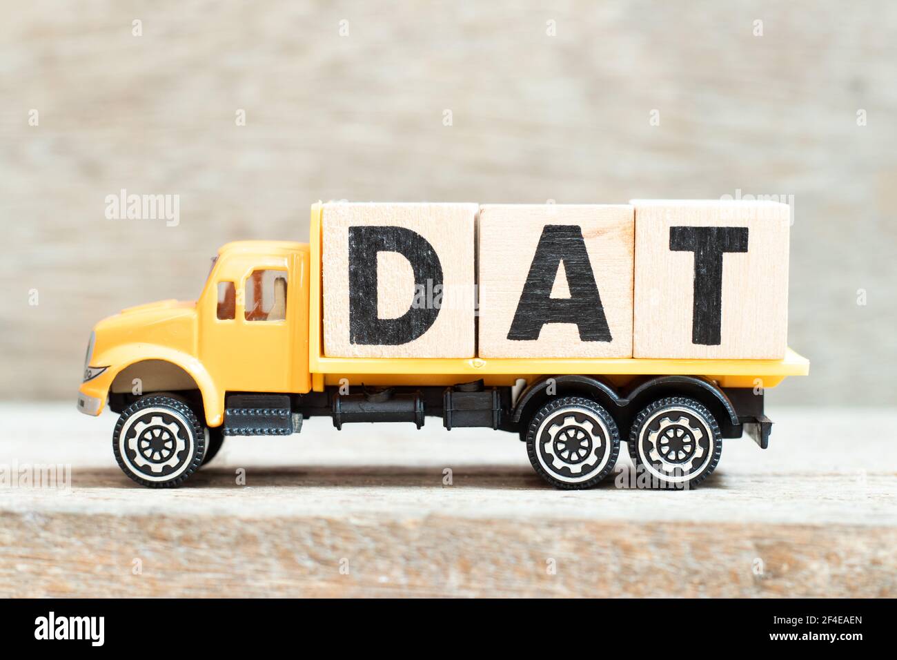 Toy truck hold alphabet letter block in word DAT (Abbreviation of ...