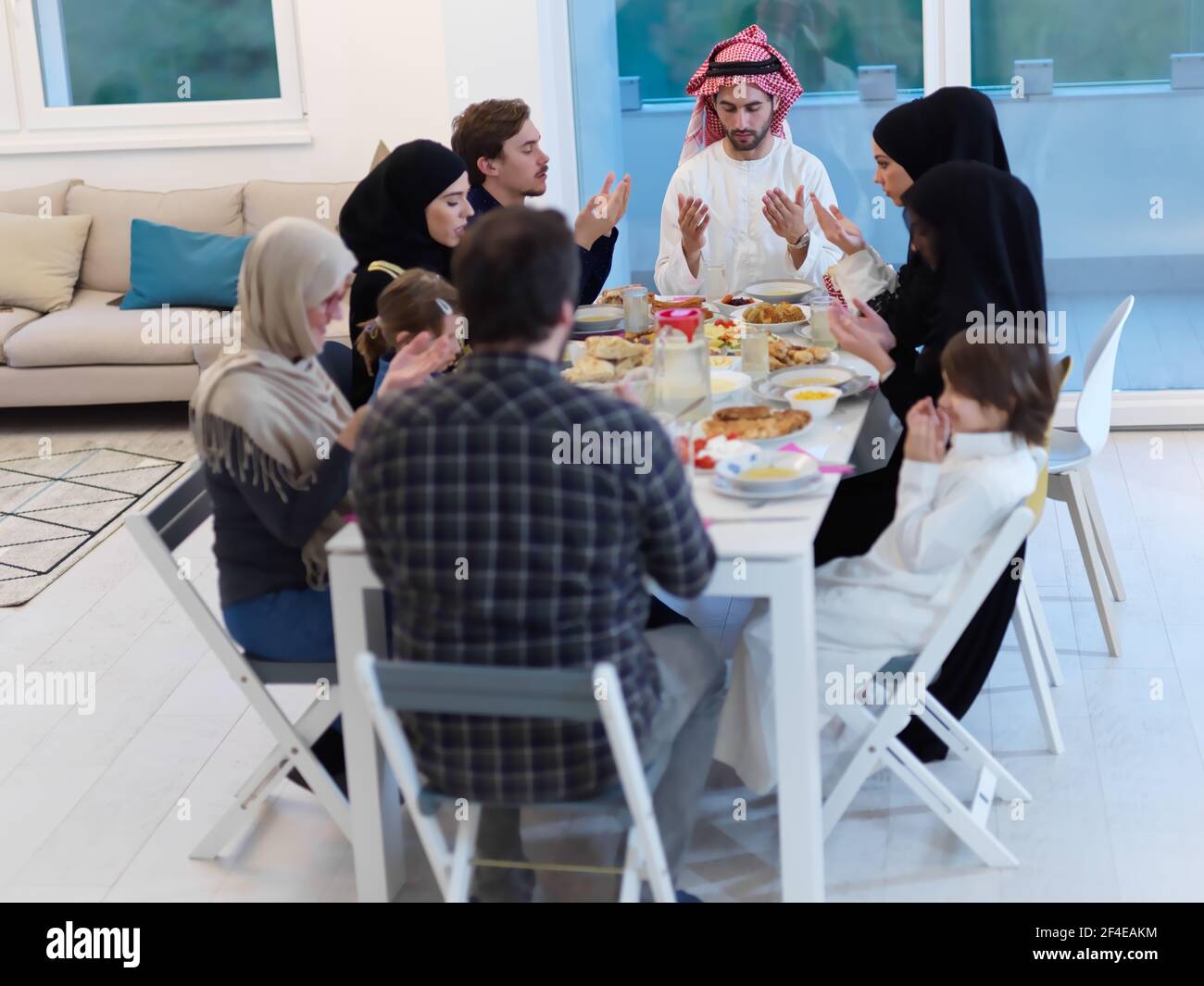 Muslim family making iftar dua to break fasting during Ramadan Stock ...