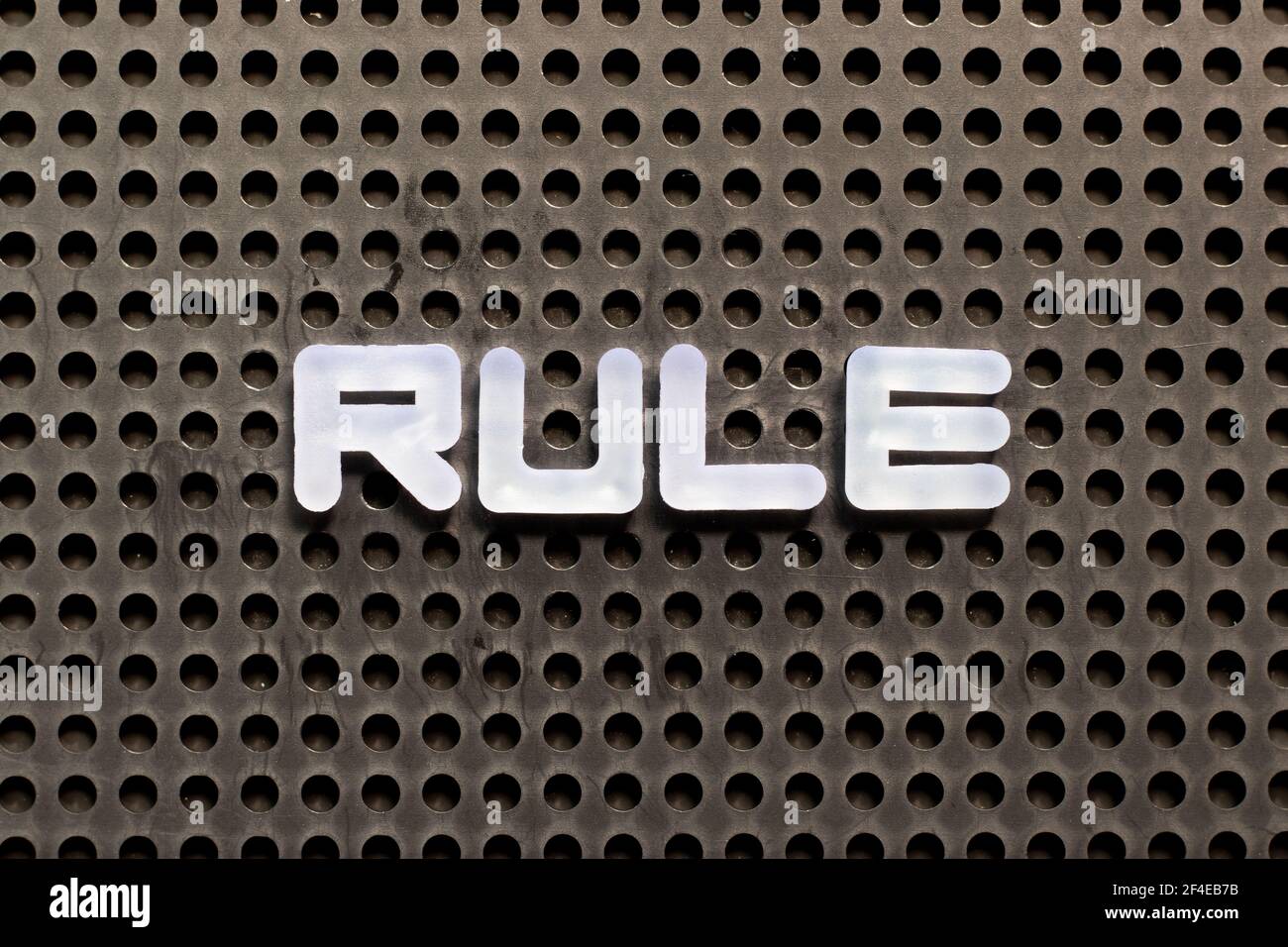 White color letter in word rule on black pegboard background Stock ...