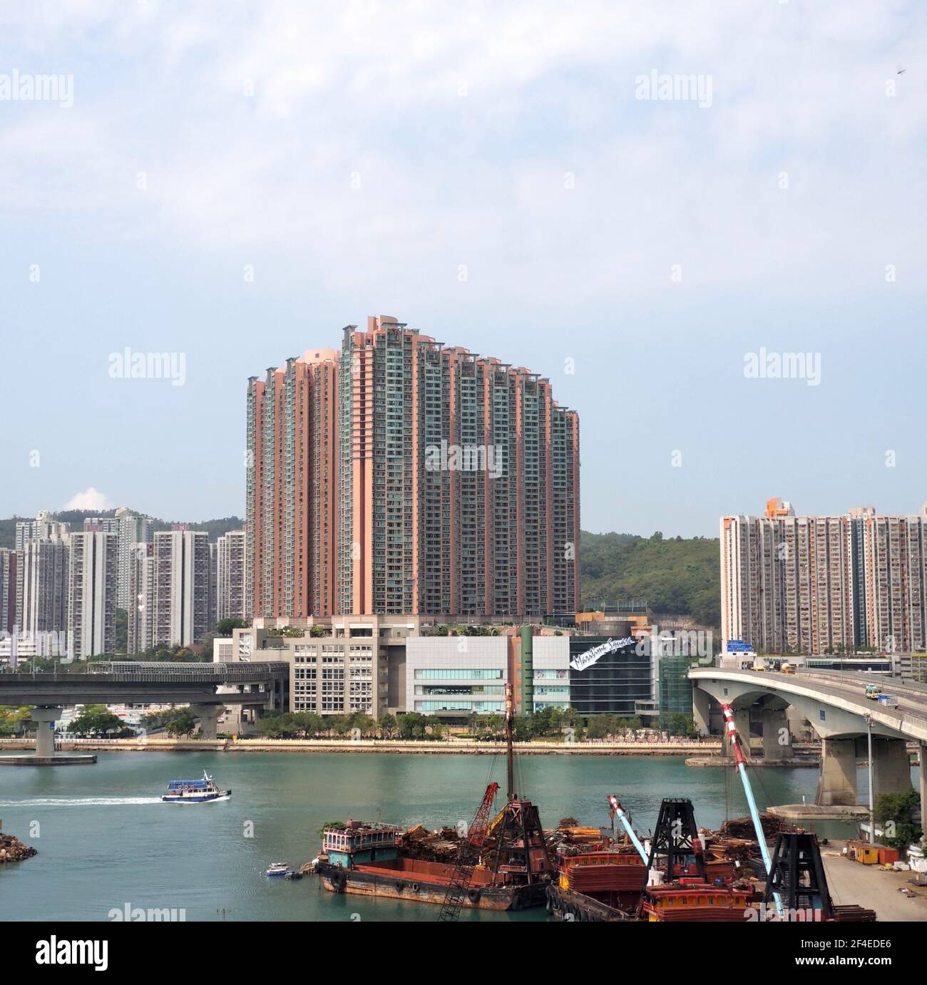 A small boat in Rambler Channel has steered past Tsing Lai Bridge and ...