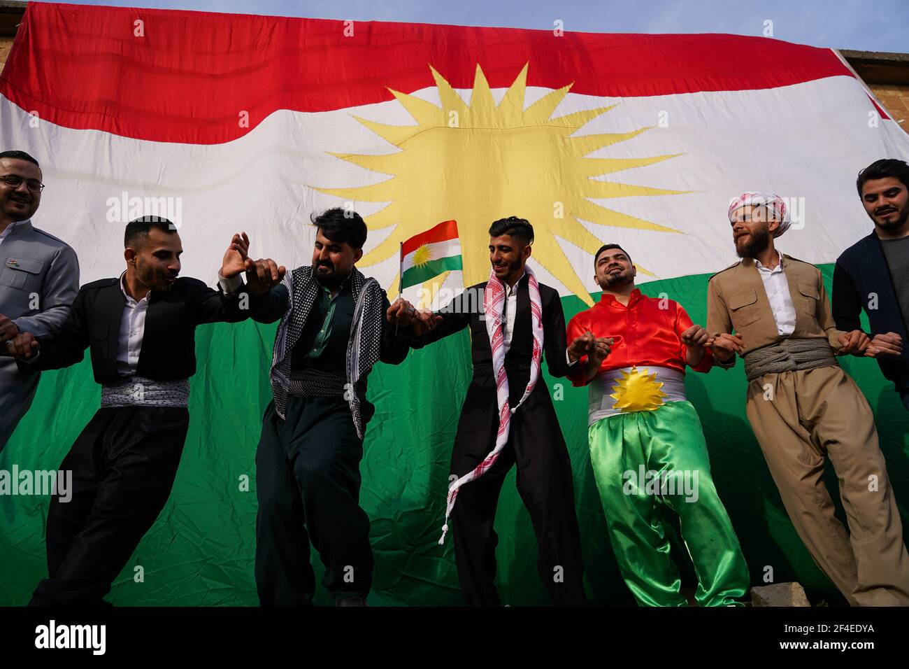 Akre, Iraq. 20th Mar, 2021. Iraqi Kurds dancing next to the Kurdistan ...