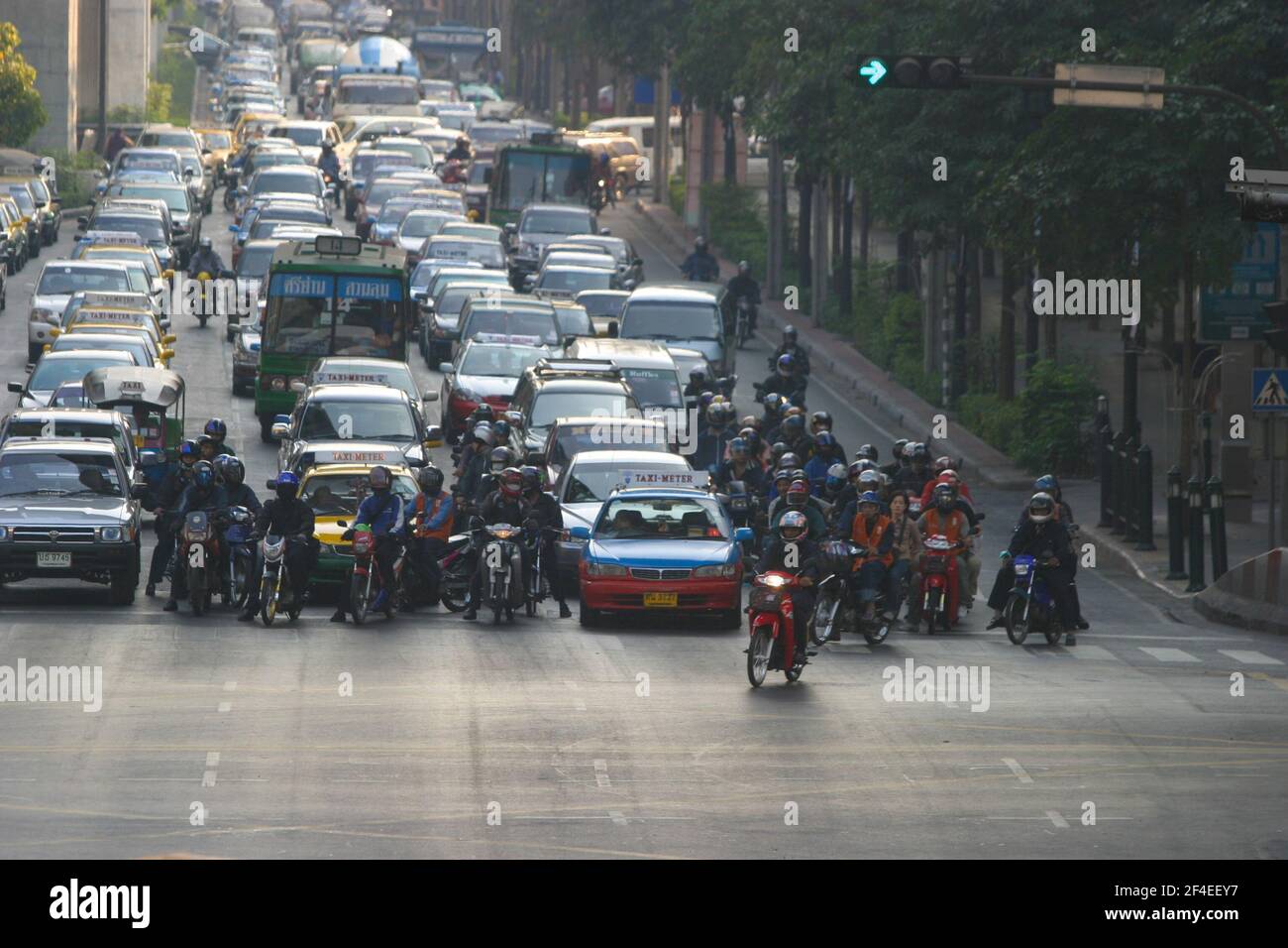 Cars, scooters and buses crowd the streets of Bangkok, Thailand ...