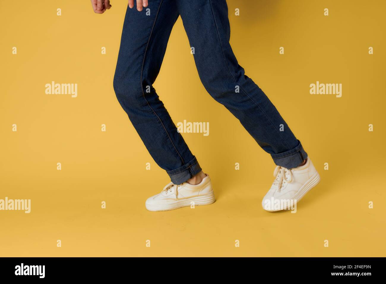 foot gesture white sneakers fashion jeans street style yellow ...