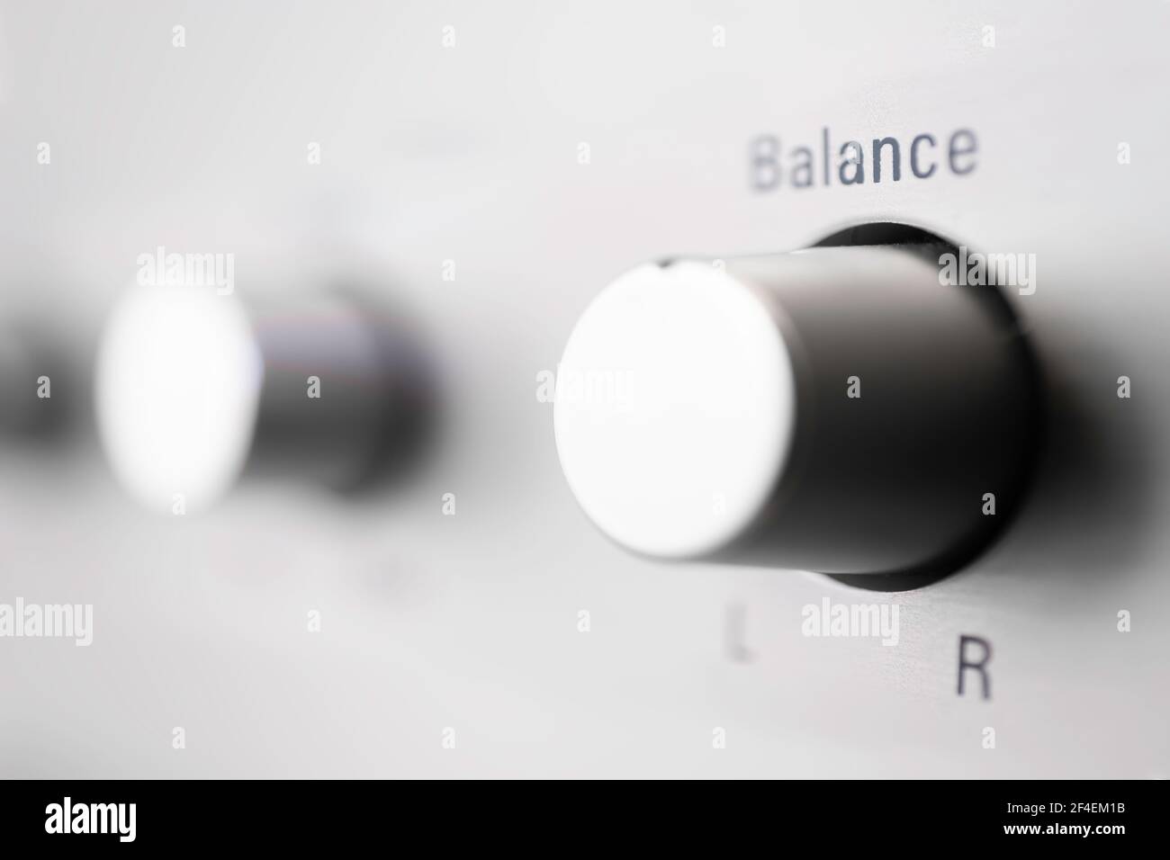 Rotary knobs on an amplifier with gray metal background. Focus on the ...