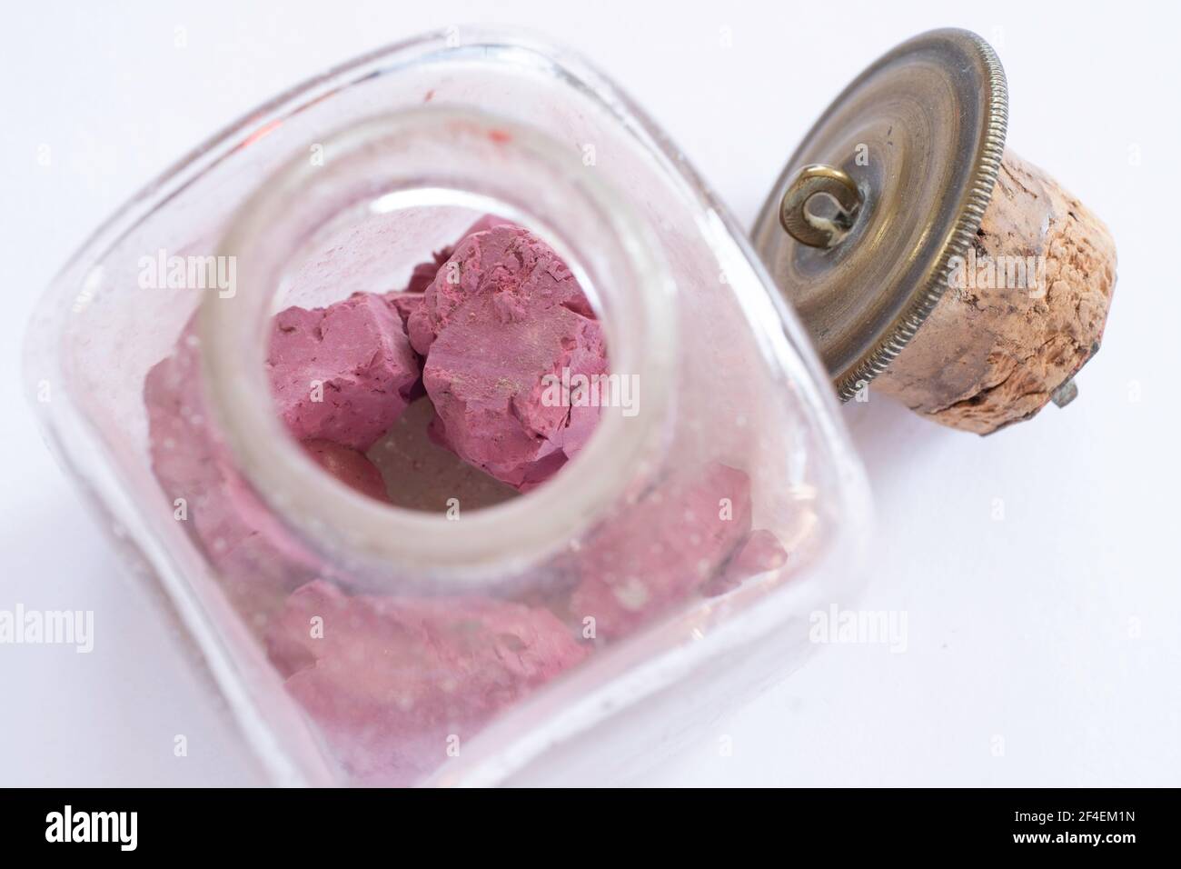 Old glass jar with original reddish dried pigment chunks to make oil ...