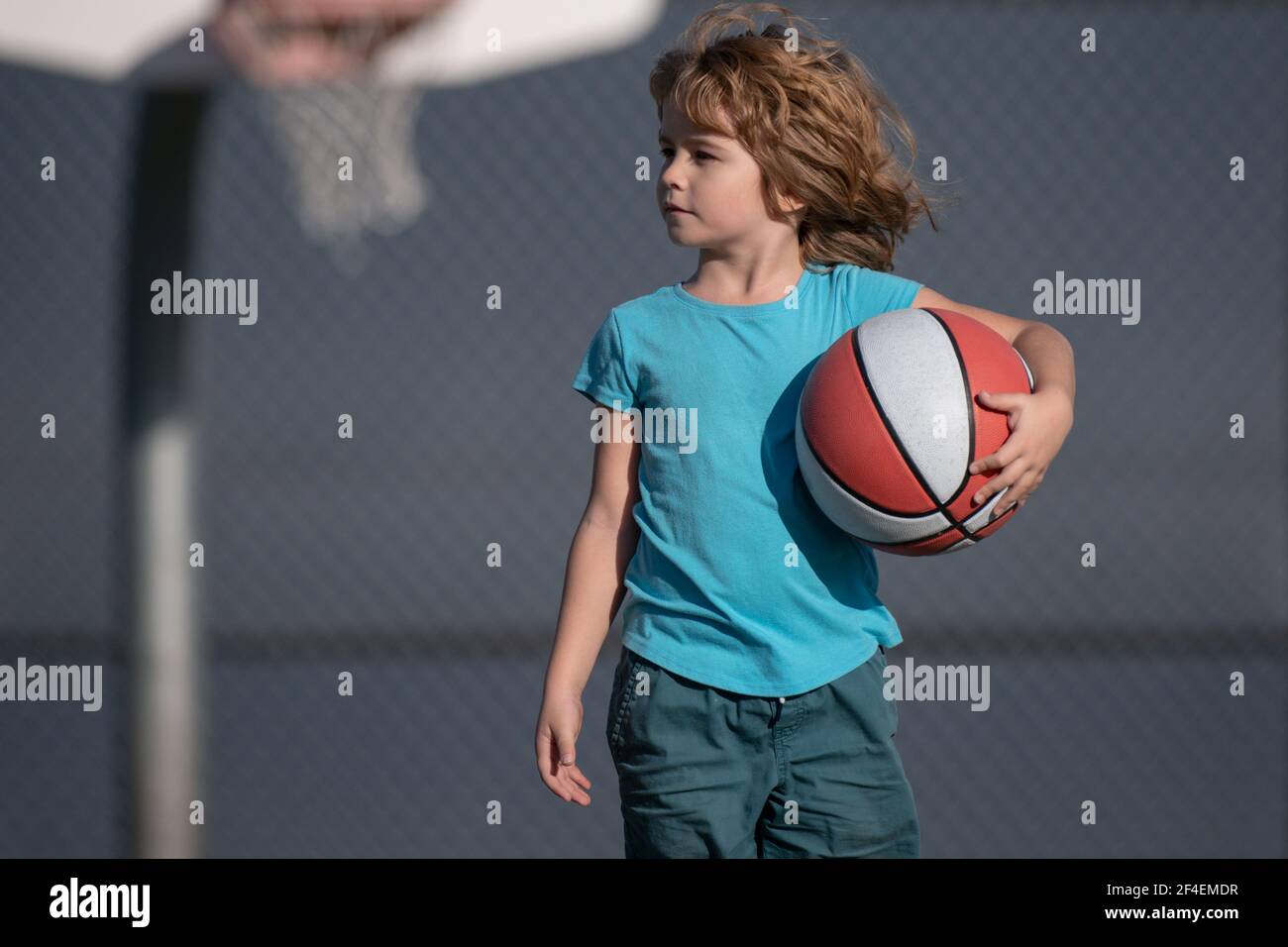 Kid playing basketball. Child boy posing with a basketball ball Stock ...
