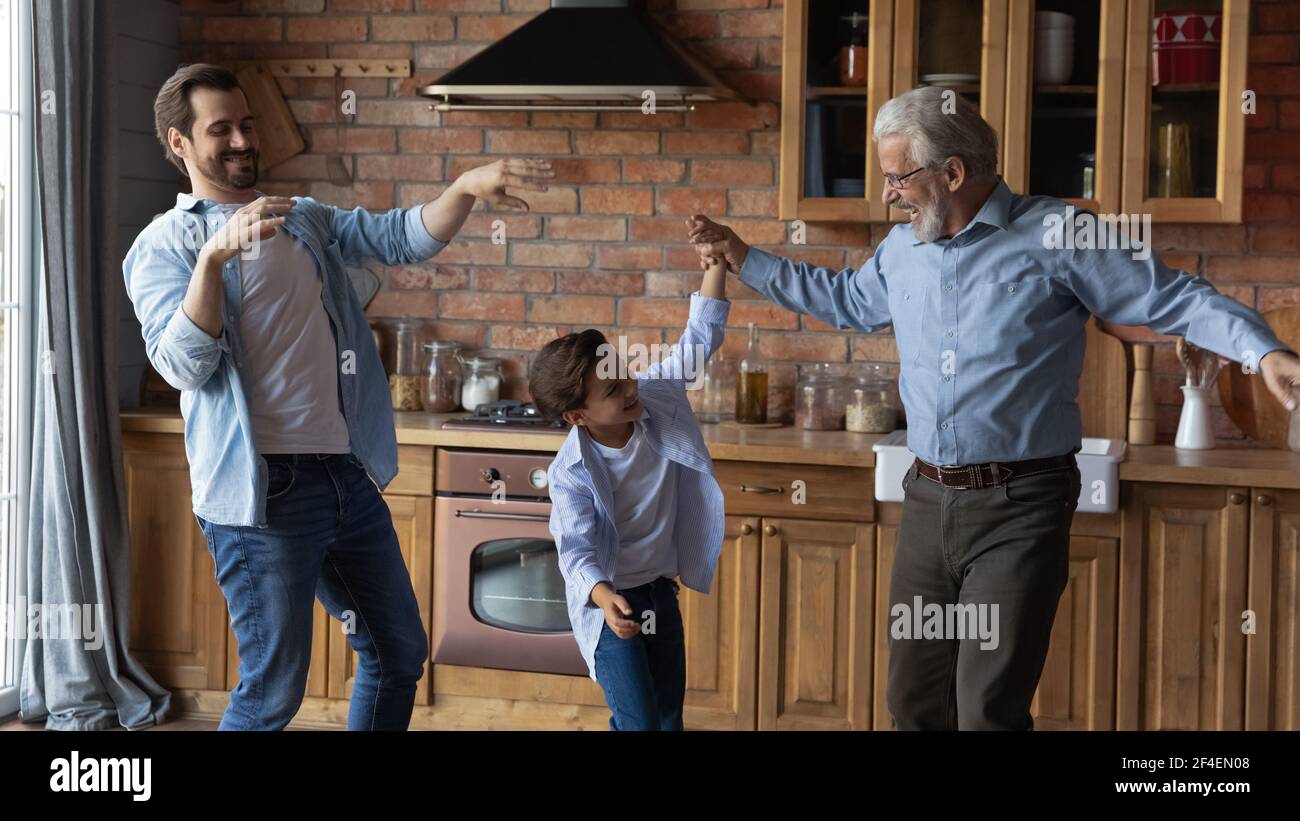 Happy three generations of men dancing at home Stock Photo - Alamy