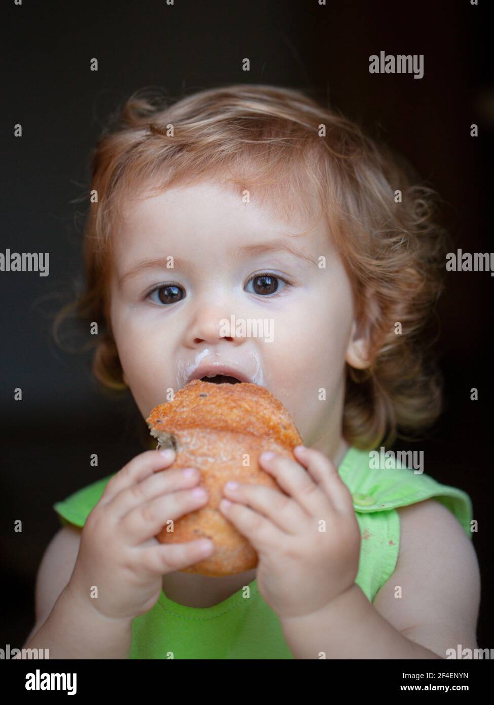 Infant eating bread hi-res stock photography and images - Alamy