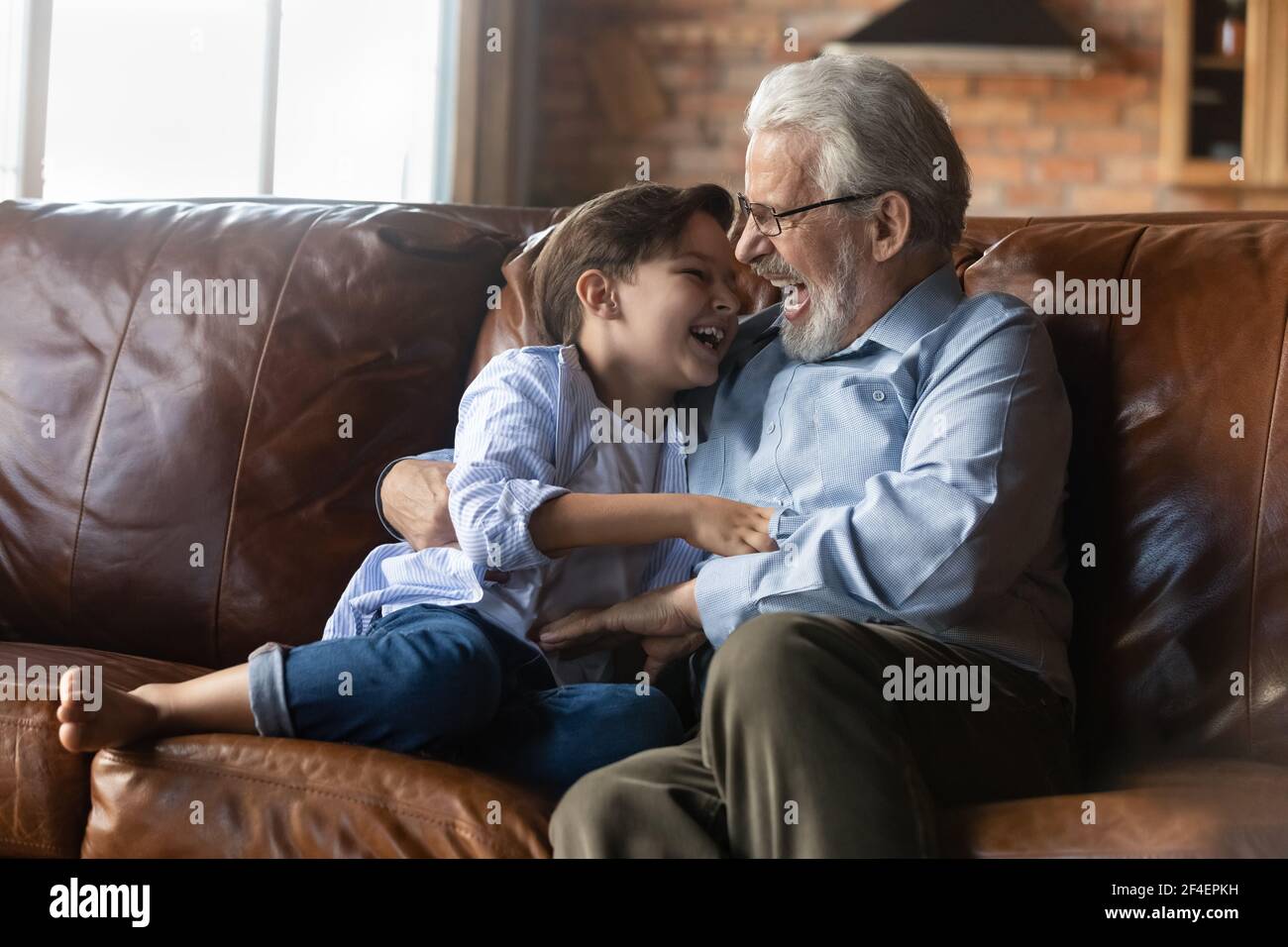 Happy old grandfather and grandson play at home Stock Photo - Alamy