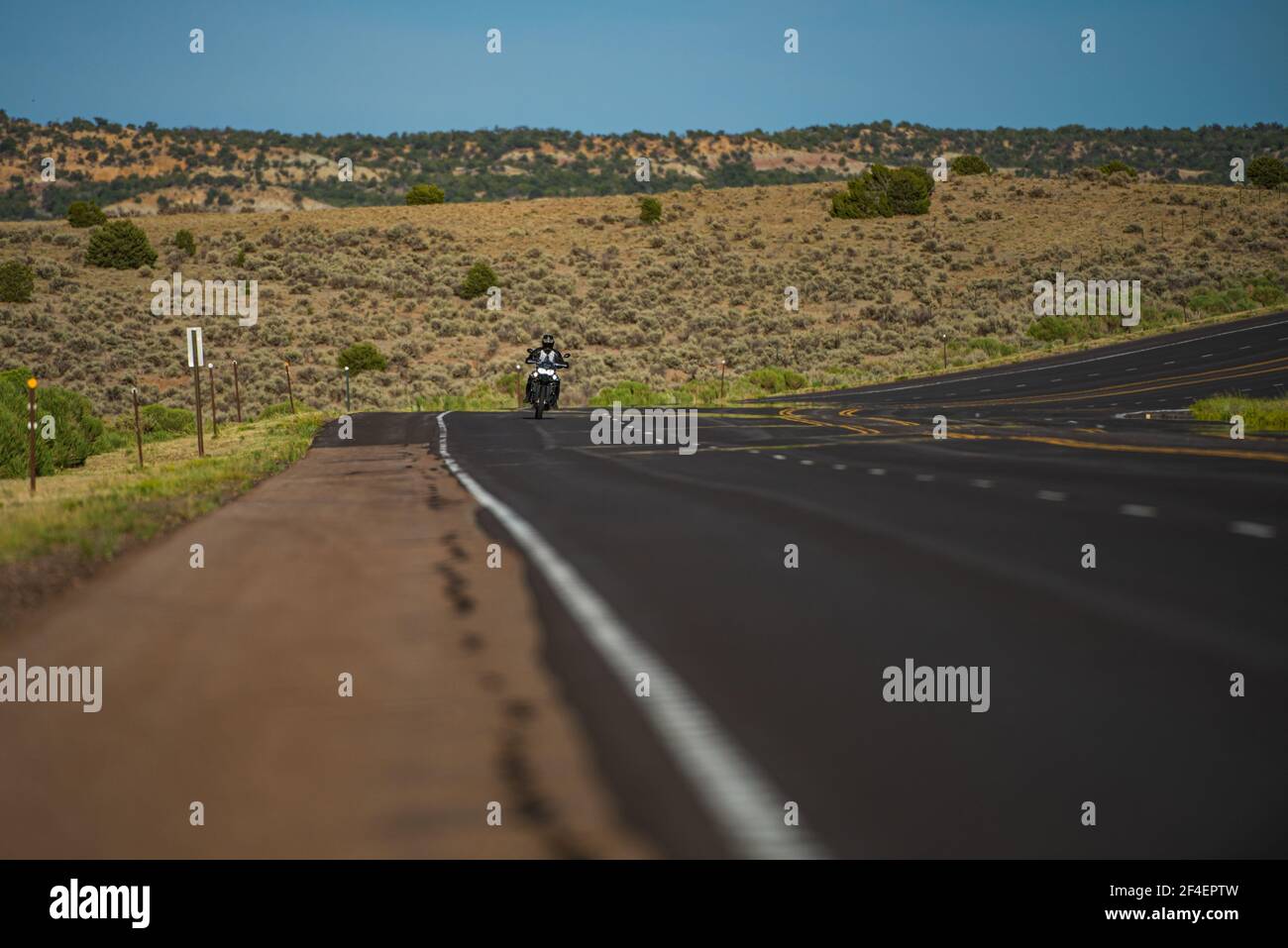 Panoramic picture of a scenic road with biker on Motorbike. American ...