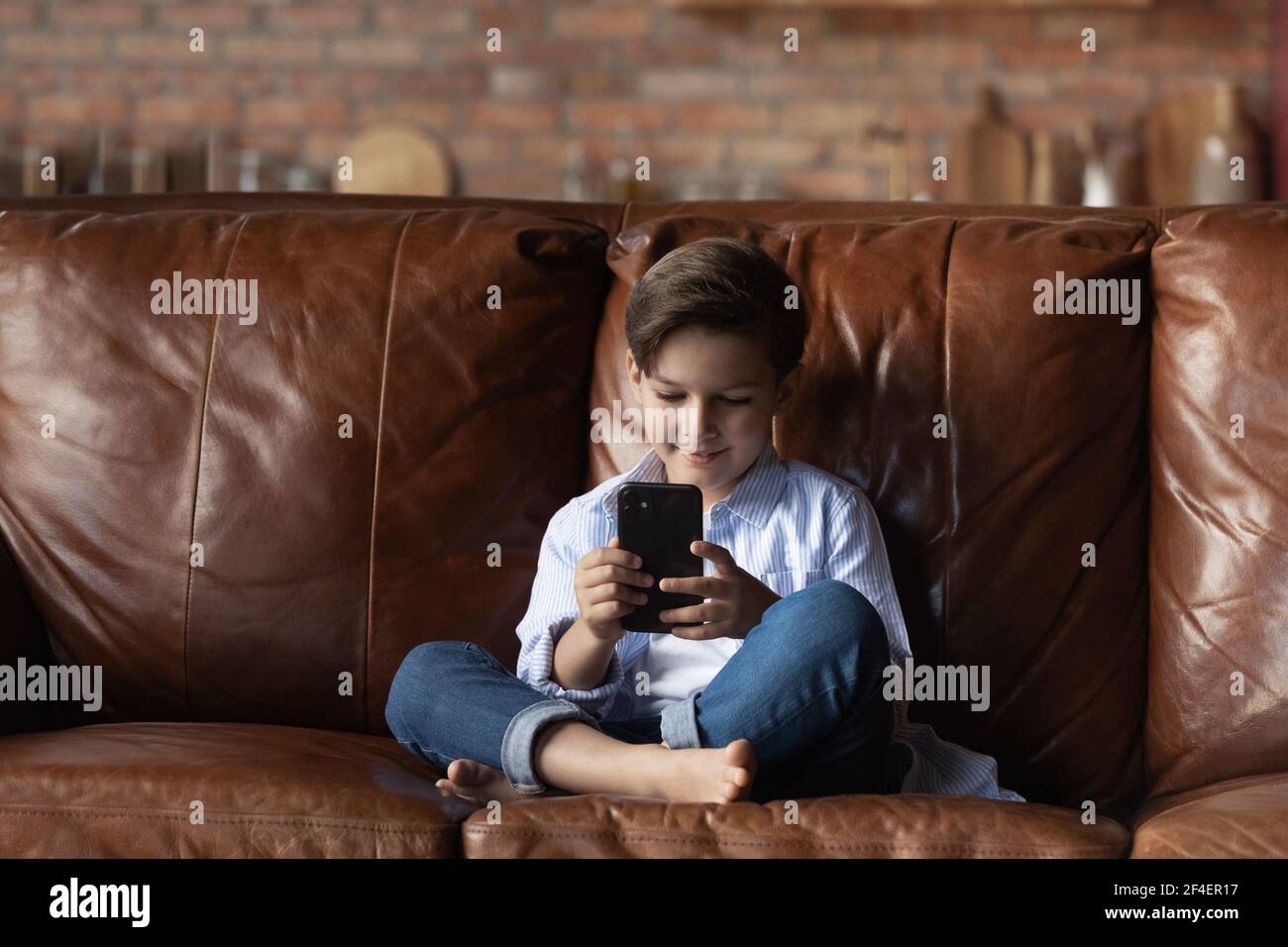 Little boy relax at home use modern cellphone Stock Photo - Alamy