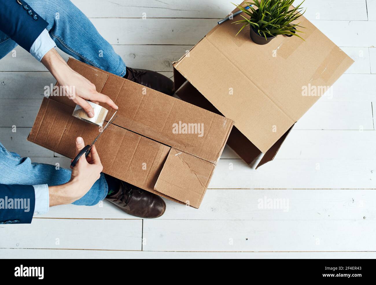 Man packing boxes moving office professional official Stock Photo - Alamy