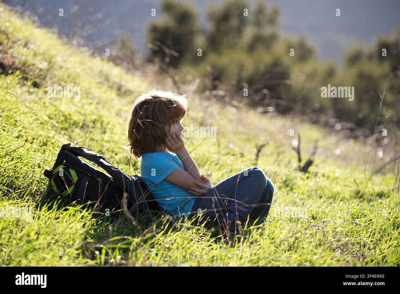 Children sitting in the high grass and admiring the beautiful views of ...