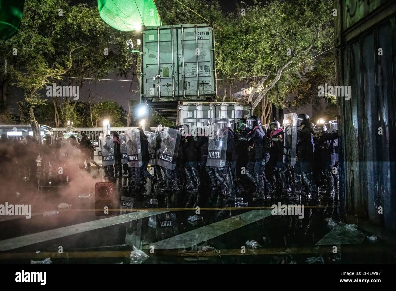 Riot police officers pass through the 'open gate' between the shipping ...