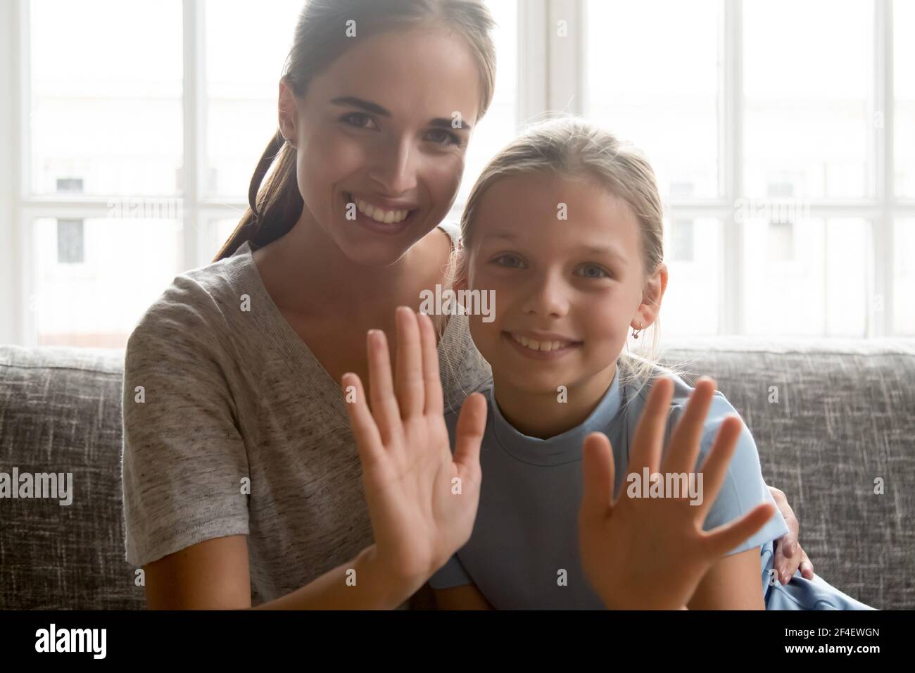 Smiling mom and daughter talk on video call Stock Photo - Alamy