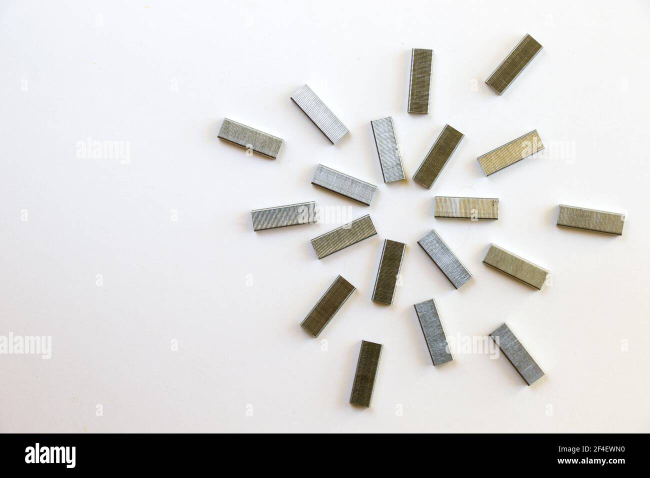 A pile of paper staples on white background Stock Photo - Alamy