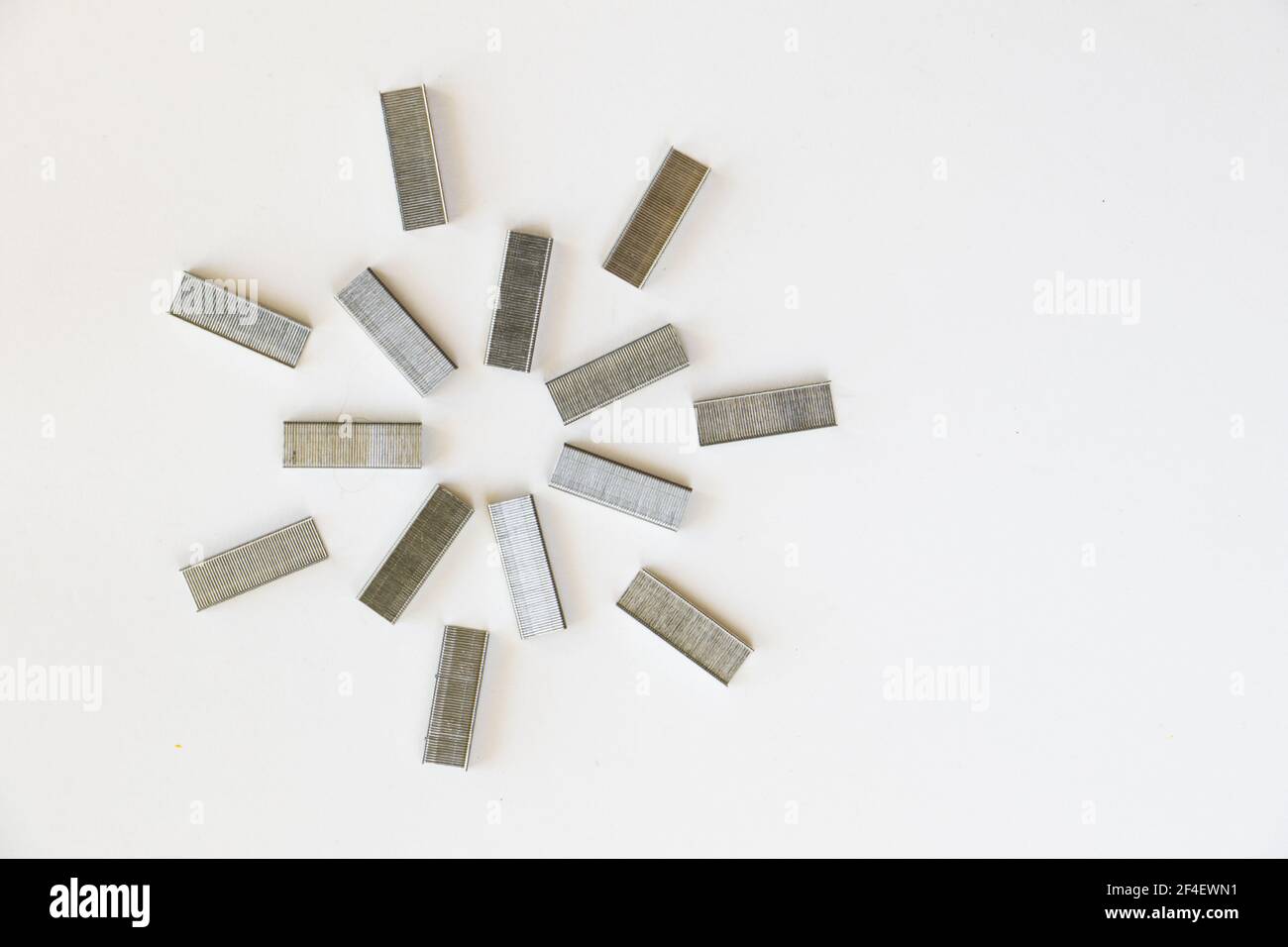 A pile of paper staples on white background Stock Photo - Alamy