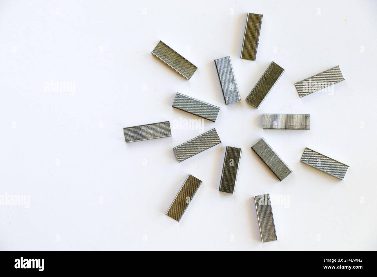 A pile of paper staples on white background Stock Photo - Alamy