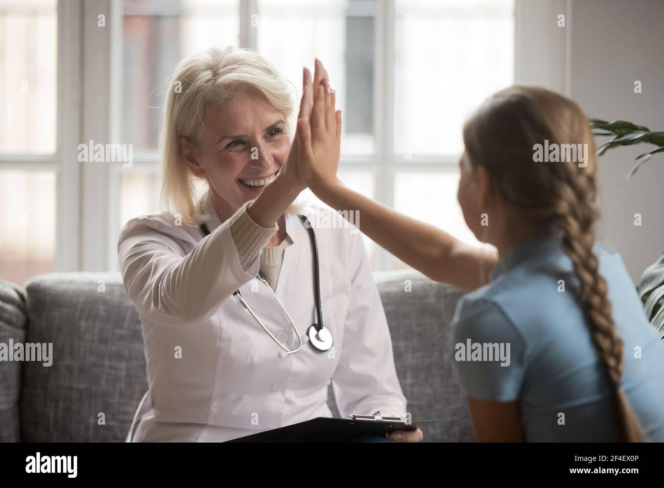 Smiling female doctor give high five to little patient Stock Photo - Alamy