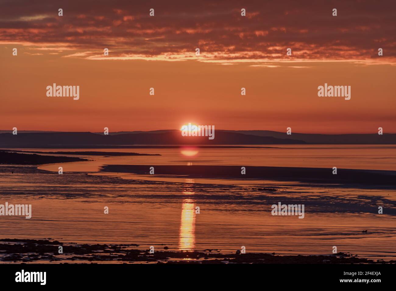 The sun reflecting onto the sea and mud Stock Photo - Alamy