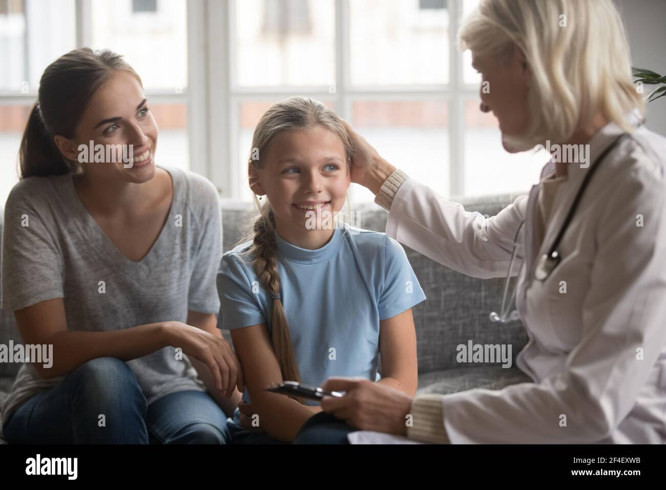 Female doctor comfort teen girl child patient Stock Photo - Alamy
