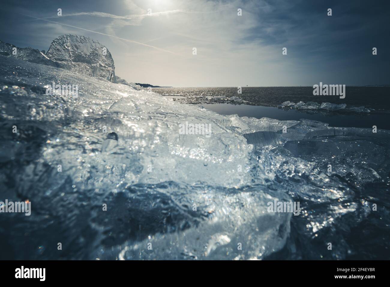 Ice floe breaking up against shore with sea ice during freezing winter ...